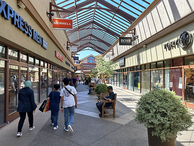 The covered walkway creates a shopping oasis where brands like Merrell and Boss beckon to passersby like retail sirens.