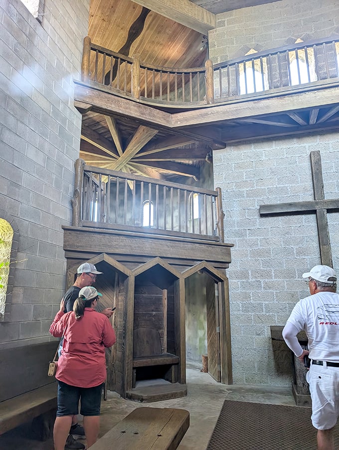 Visitors explore the castle's multi-level interior, where rustic wooden elements contrast beautifully with the stone walls' medieval solidity.