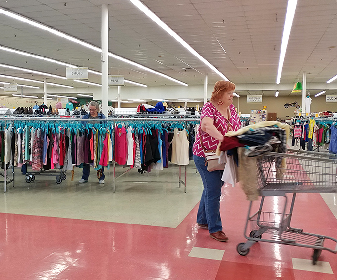 Serious thrifters know the joy of the hunt. This shopper's cart suggests she's struck gold in the clothing department.