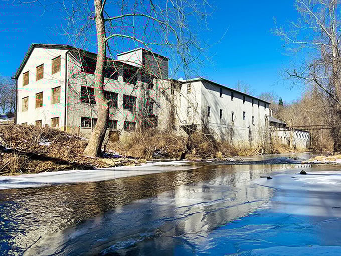 Historic mill buildings whisper stories of Delaware's industrial past while the creek provides soothing background music.