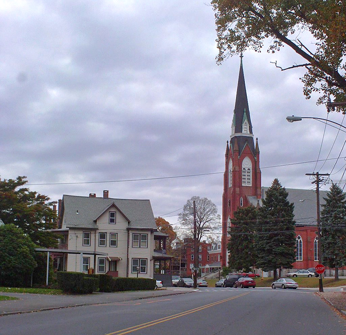 Derby's impressive stone and brick building dominates the corner, its architectural details hinting at the town's prosperous industrial heritage.
