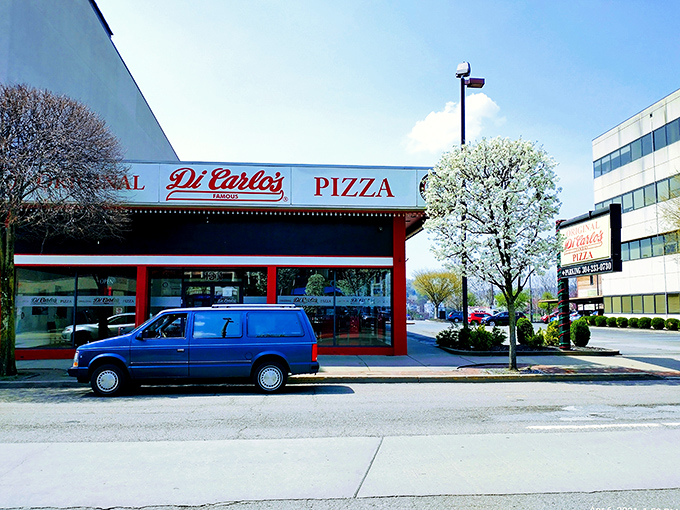DiCarlo's classic storefront stands proudly on the street, a no-nonsense beacon for square-cut pizza aficionados.