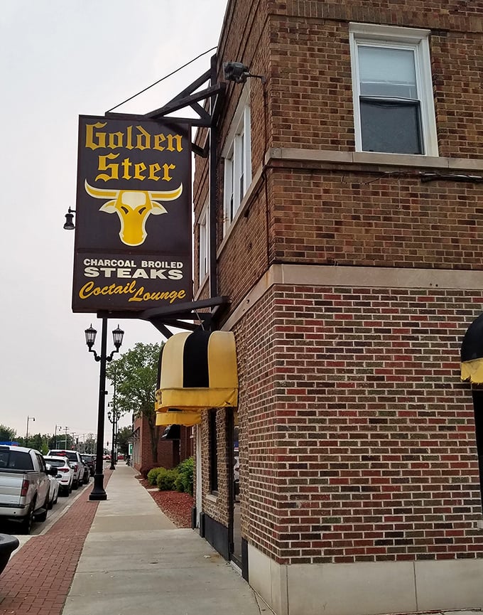 The golden steer sign glows like a beacon for anyone who understands that charcoal makes everything better.