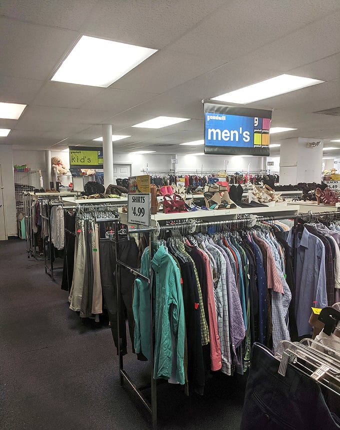 Goodwill's men's department stretches to the horizon. Those blue signs overhead are like constellations guiding you to your next great find.