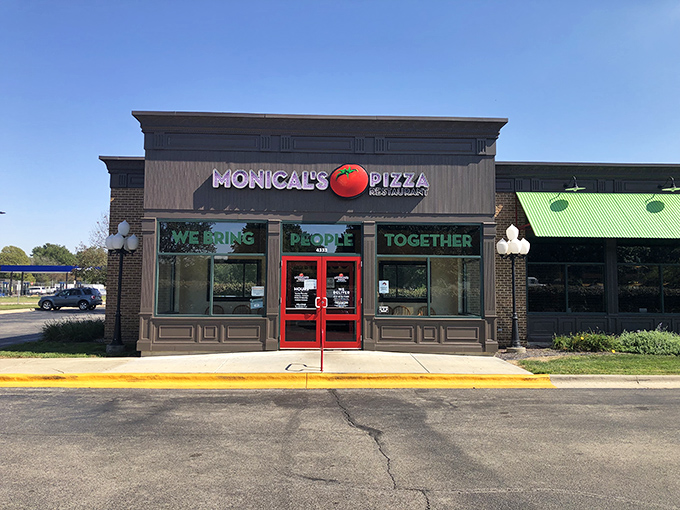 Monical's clean storefront might look modest, but that tomato logo signals thin-crust greatness lies within.