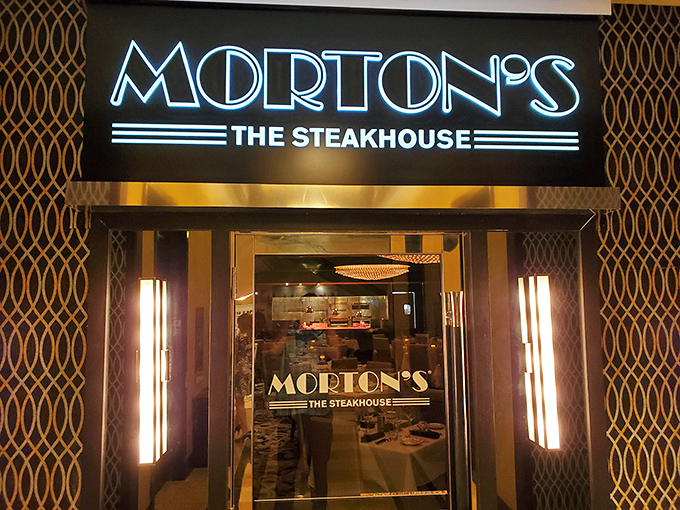 Morton's entrance glows with promise like a beacon for beef enthusiasts. That elegant sign might as well say "steak paradise ahead."
