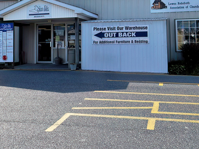 New Life Thrift Shop's sign points to their furniture warehouse. Like a treasure map where X marks the spot for that perfect armchair.