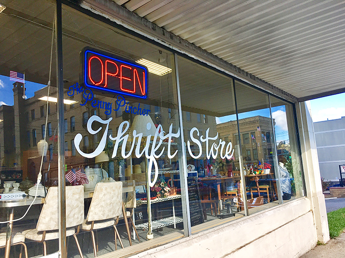 "Open" glows like a beacon at Penny Pincher Thrift Store. Inside those windows, bargains multiply faster than dust bunnies under the bed.