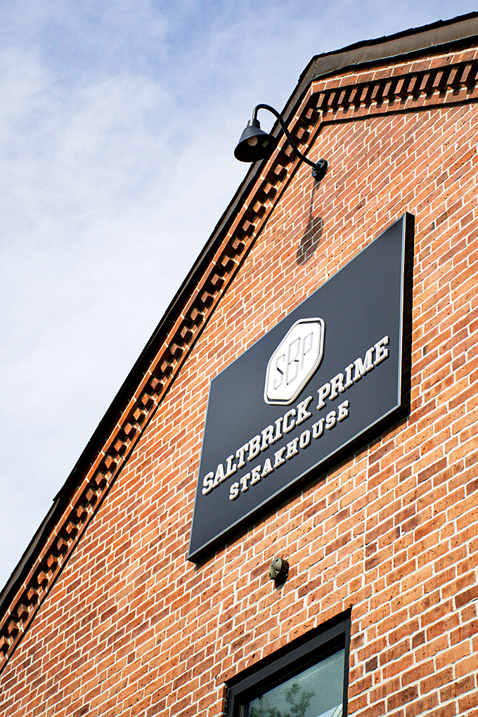 That sleek sign against brick is like the Batman signal for steak lovers – your meaty adventure awaits.