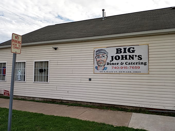 The simple white siding and welcoming sign at Big John's promise honest food without pretension. Sometimes the best meals come in humble packages.