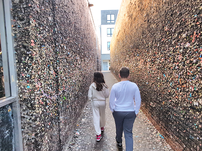 Visitors navigate the narrow passage between walls of chewed gum, where art and ick factor collide in spectacular fashion.