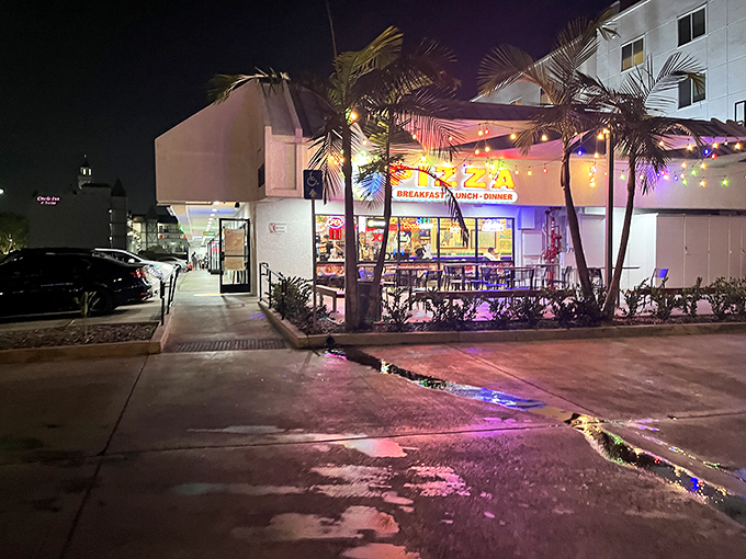 By night, this Anaheim pizza joint glows with inviting lights – a beacon for hungry theme park visitors seeking refuge from overpriced food.