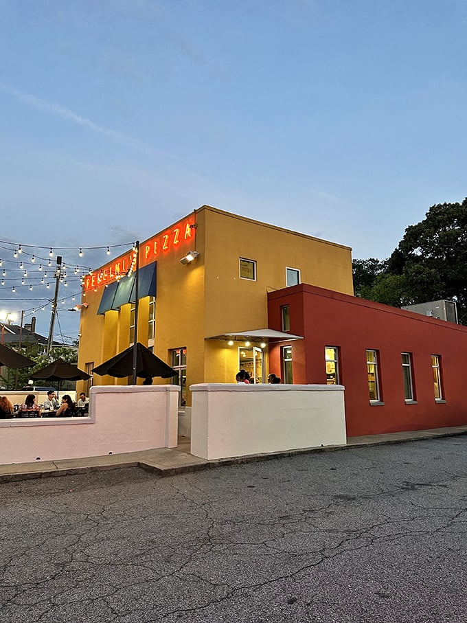 Twilight at Fellini's transforms the bright yellow building into a glowing beacon for pizza lovers. String lights add just the right touch of magic.