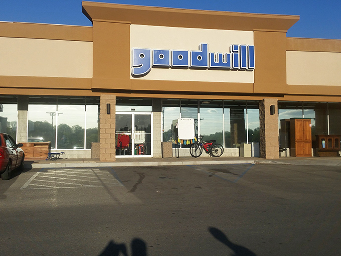 Morning light catches Goodwill's storefront, promising a day of discoveries that help fund job training programs.