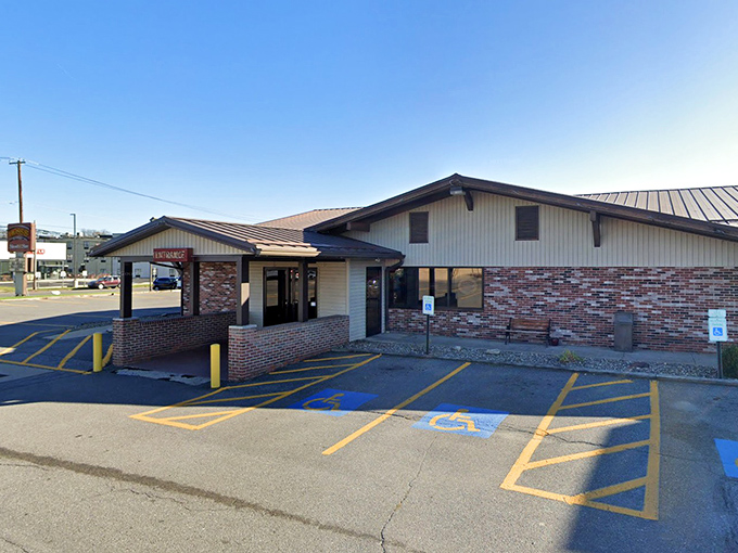 Behind this unassuming brick facade lies a temple to the art of flame-grilled perfection and salad bar abundance.