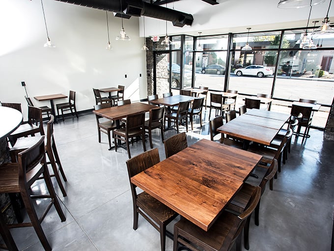 Clean lines and wooden tables create the perfect stage for the real performance &ndash; watching your pizza transform in the wood-fired oven.