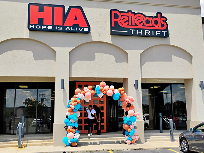 Colorful balloons frame the entrance like a celebration waiting to happen. Each purchase here supports recovery programs with real impact.