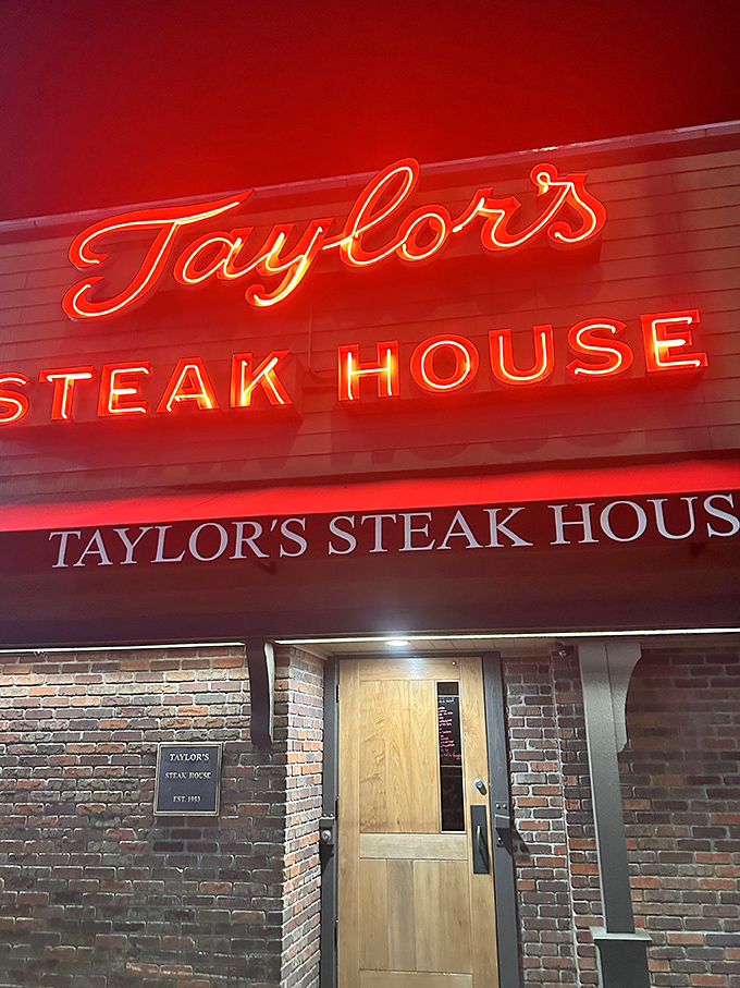 The red neon glow of Taylor's at night acts like a tractor beam for serious steak lovers seeking refuge from culinary trends.