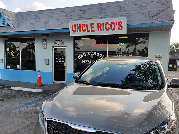 That glowing "OPEN" sign at Uncle Rico's is Fort Myers' bat signal for pizza lovers seeking the real deal.