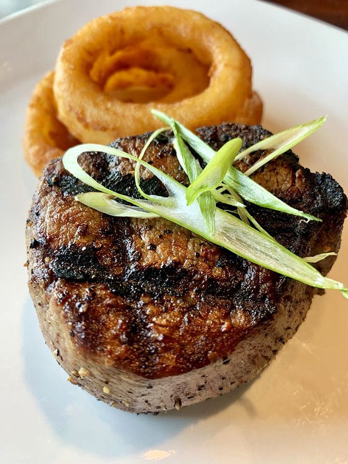 This filet mignon has the kind of perfect crust that makes steak lovers weak at the knees. That onion ring isn't just a garnish—it's the crown jewel.