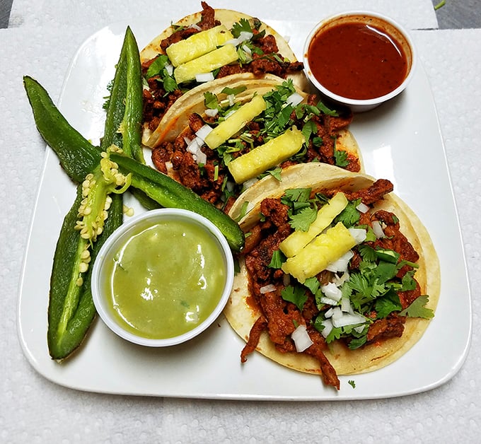 Al pastor tacos served with nature's perfect garnish&mdash;a roasted jalape&ntilde;o that dares you to take the heat while green and red salsas stand by as flavor reinforcements.