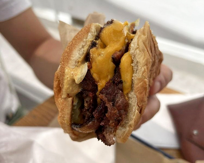 The burger that launched a thousand napkins. Juicy, messy perfection that reminds you why hands were invented before forks.