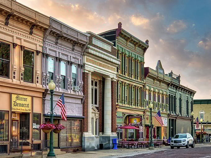 Downtown Mount Carroll at golden hour&mdash;where American flags flutter above brick streets, and storefronts glow with the patina of genuine history.