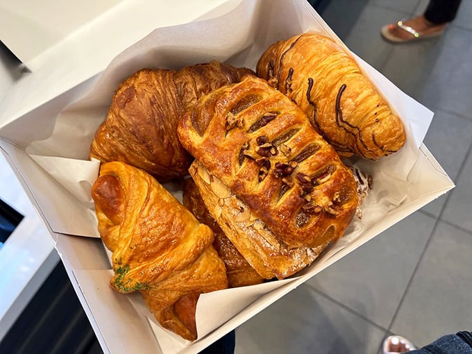 Croissants that would make a Parisian nod in approval – each one a buttery miracle of flaky layers that shower your shirt with evidence of your excellent life choices.