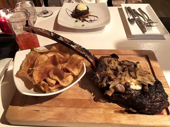 The tomahawk ribeye arrives like a prehistoric trophy. Perfectly charred exterior giving way to a buttery-tender interior that practically dissolves on contact. 