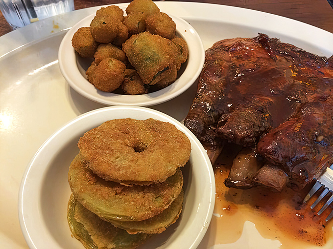 Those ribs look like they've been slow-cooking since the Carter administration. The fried green tomatoes stacked like poker chips are the South's version of currency.