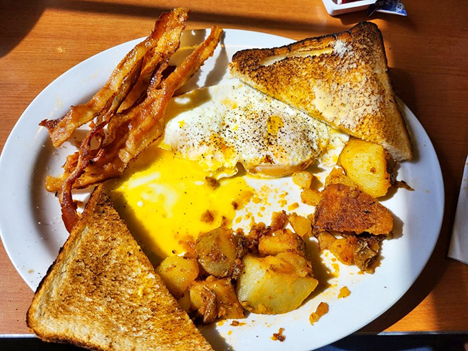 Sunny-side up perfection with toast golden enough to make King Midas jealous. Those home fries are the unsung heroes of this breakfast symphony. 