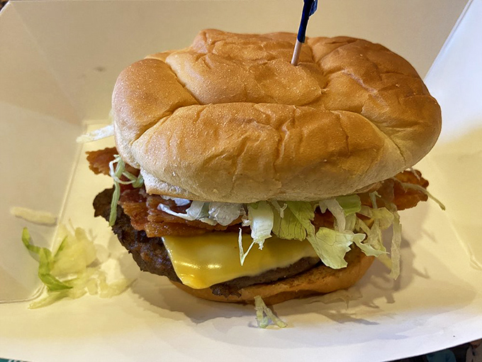 A burger that requires jaw exercises beforehand &ndash; layers of bacon, cheese, and fresh veggies stacked higher than your weekend to-do list.