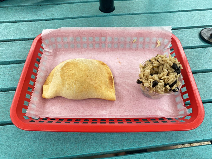 This empanada isn't just food; it's architecture. A perfect half-moon of pastry housing seasoned beef that would make Ferdinand and Isabella reconsider sailing back to Spain.