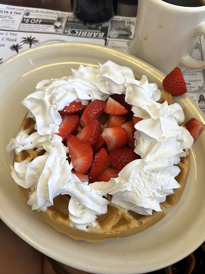 The star attraction in all its glory &ndash; a Belgian waffle crowned with fresh strawberries and whipped cream. Breakfast or dessert? The correct answer is "Yes."