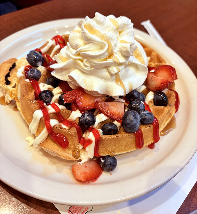 Waffle perfection crowned with fresh berries and whipped cream that defies gravity. Breakfast or dessert? At Grumpy's, no one's judging either way.