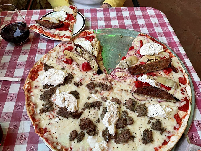 Pizza that strikes the perfect balance between American abundance and Italian authenticity, with toppings arranged like an edible work of abstract art.