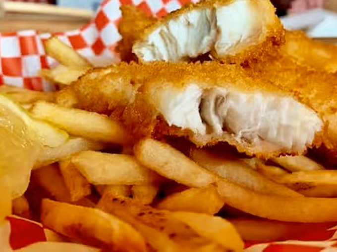 Look at that perfect cross-section! The fish is so tender it practically flakes apart with a stern glance. Paired with those fries, it's a match made in culinary heaven.