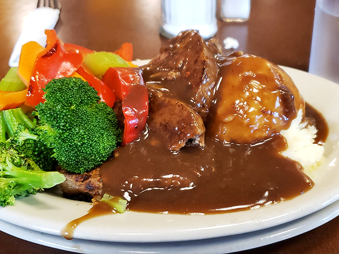 Behold the star attraction! Thick-cut meatloaf with colorful vegetables and a gravy so good you'll want to drink it with a straw.