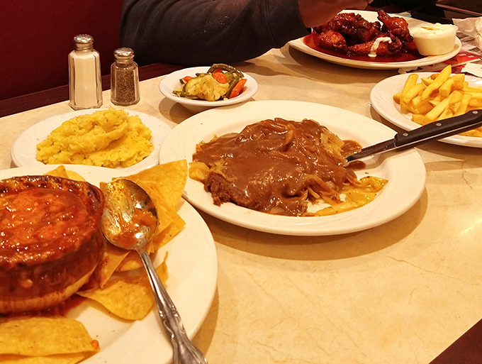 Dinner table nirvana! The spread before you &ndash; comfort classics done right, with that gravy-smothered meatloaf taking center stage. This is what food dreams are made of.