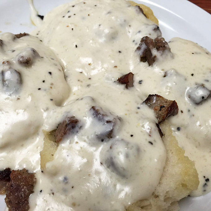 Biscuits swimming in pepper-flecked gravy &ndash; Southern comfort on a plate. This is what clouds would taste like if they were made of butter and happiness.