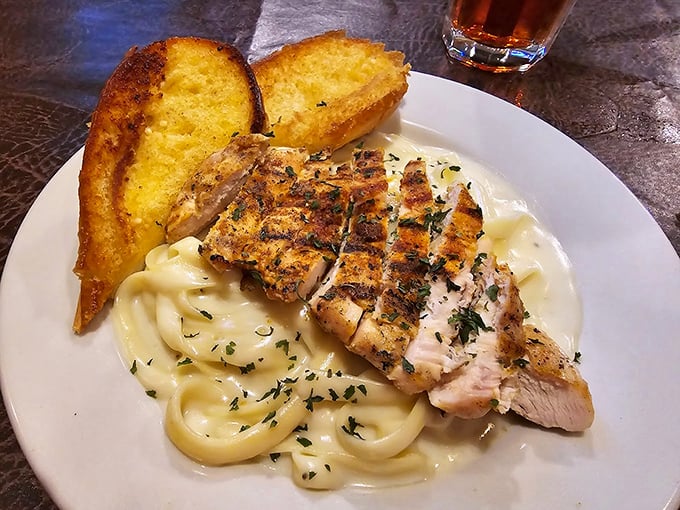 Blackened chicken lounging on a bed of creamy alfredo with Texas toast standing guard&mdash;a Southern comfort trifecta that demands to be devoured.