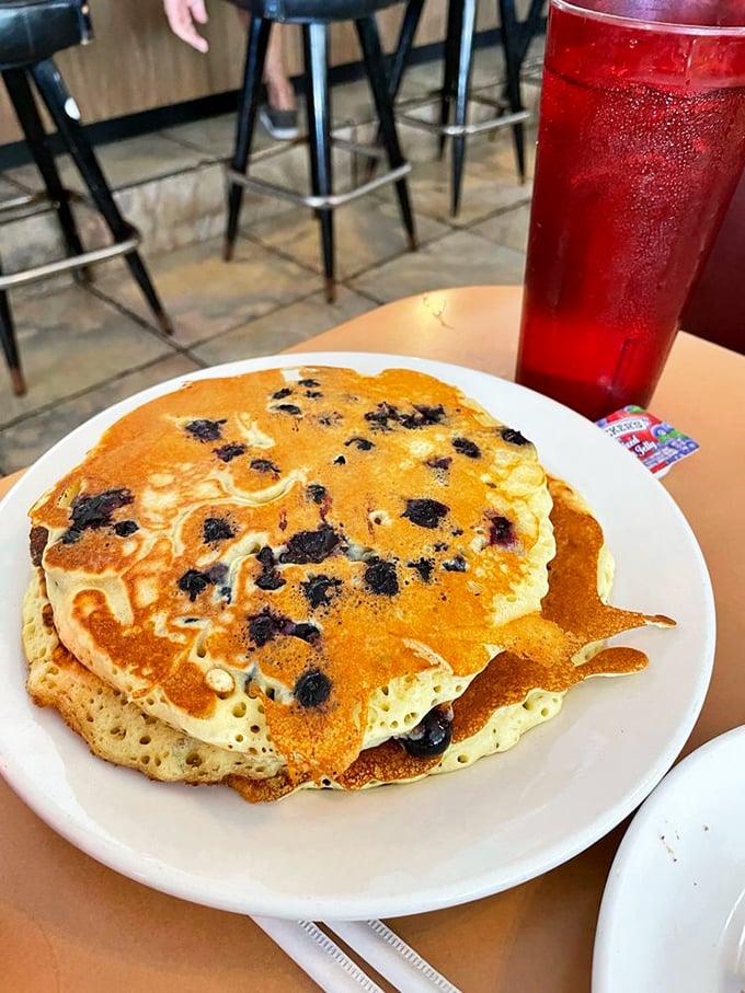 Blueberry pancakes that achieve the impossible: crispy edges, fluffy centers, and berries that burst with sunshine in every bite.