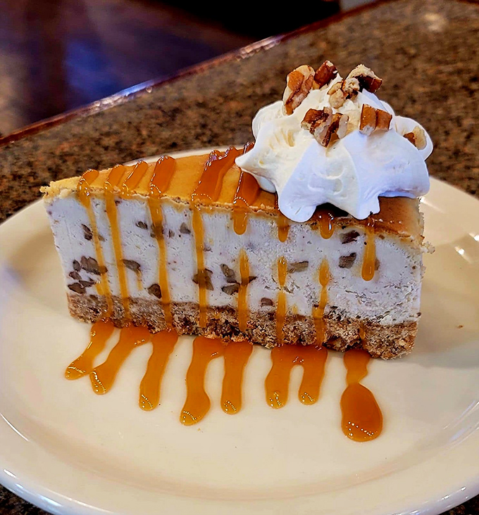 Bourbon pecan cheesecake that makes you wonder if dessert should be regulated. The whipped cream crown is just showing off.