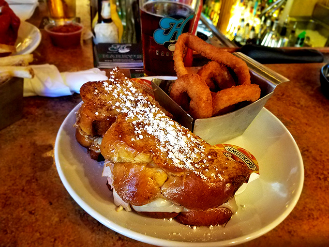 French toast that's had a glow-up &ndash; powdered sugar snowfall and a side of onion rings because why choose?
