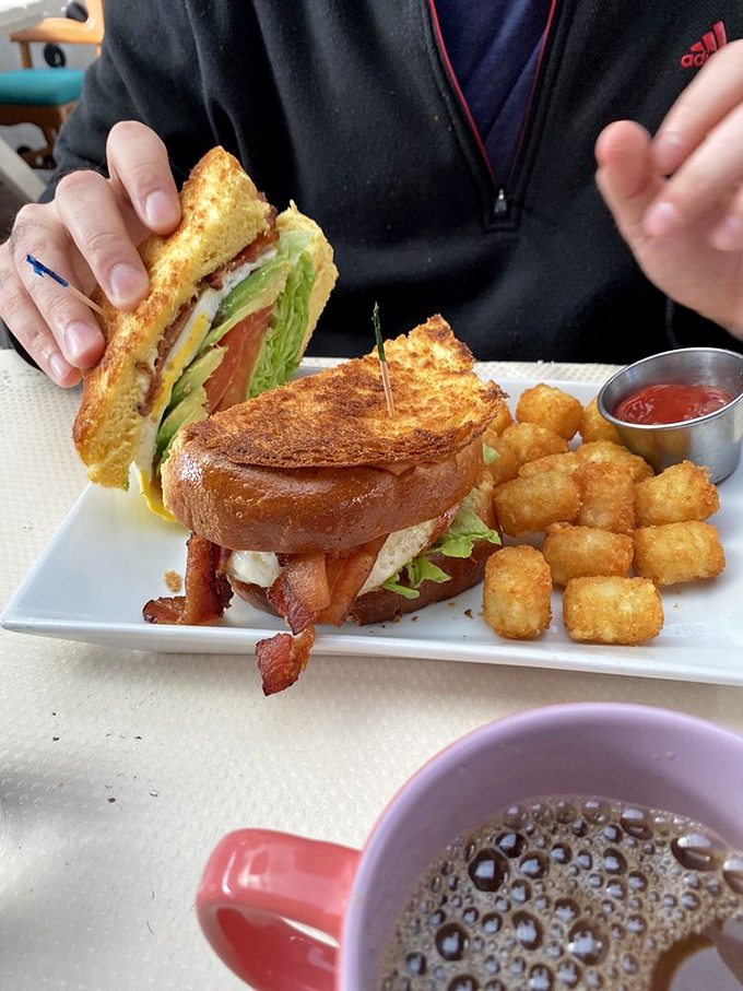 The breakfast sandwich that launched a thousand Instagram posts. Crispy bacon, fresh greens, and golden bread&mdash;with tater tots playing a delicious supporting role.