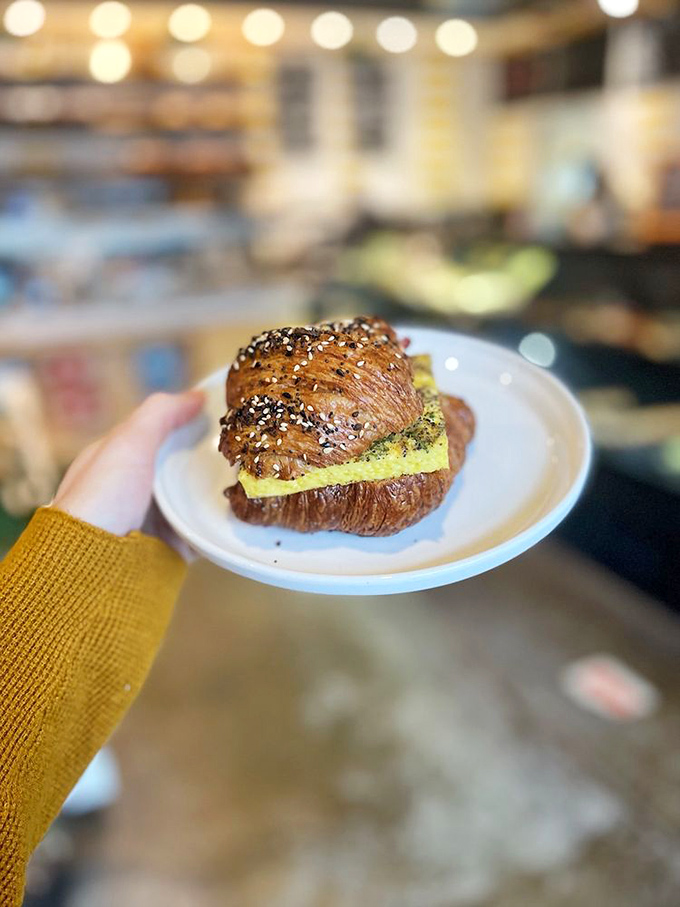 Breakfast sandwiches should always look this good—a golden croissant embracing eggs and fillings like a warm morning hug.