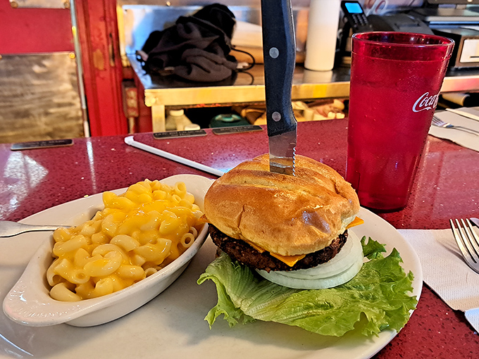 This burger doesn't just sit on the plate&mdash;it commands attention, flanked by mac and cheese that's unapologetically yellow and gloriously comforting.