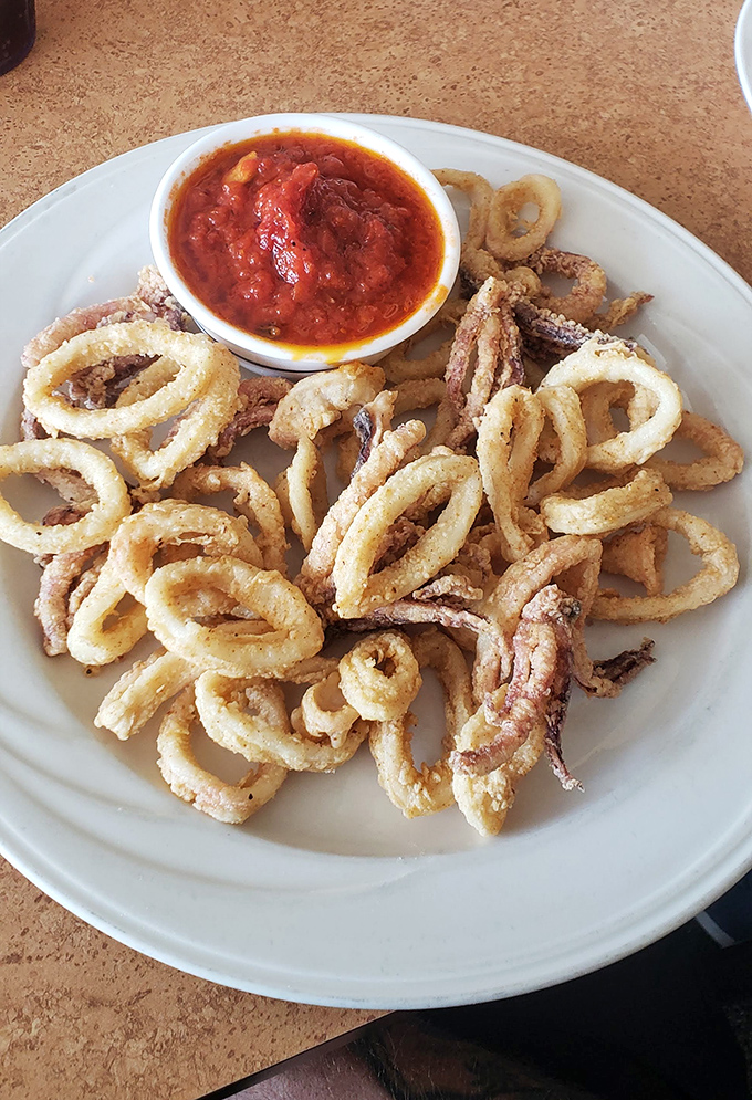 Calamari rings stacked like delicious golden halos, with marinara for dipping. Crispy, tender, and never rubbery&mdash;the seafood trifecta.
