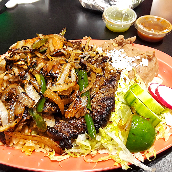 Carne asada that's been kissed by fire and blessed by spices, served with the respect it deserves alongside perfect rice and beans.