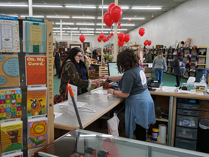 Red balloons and genuine smiles create the kind of shopping atmosphere that makes every visit feel special.
